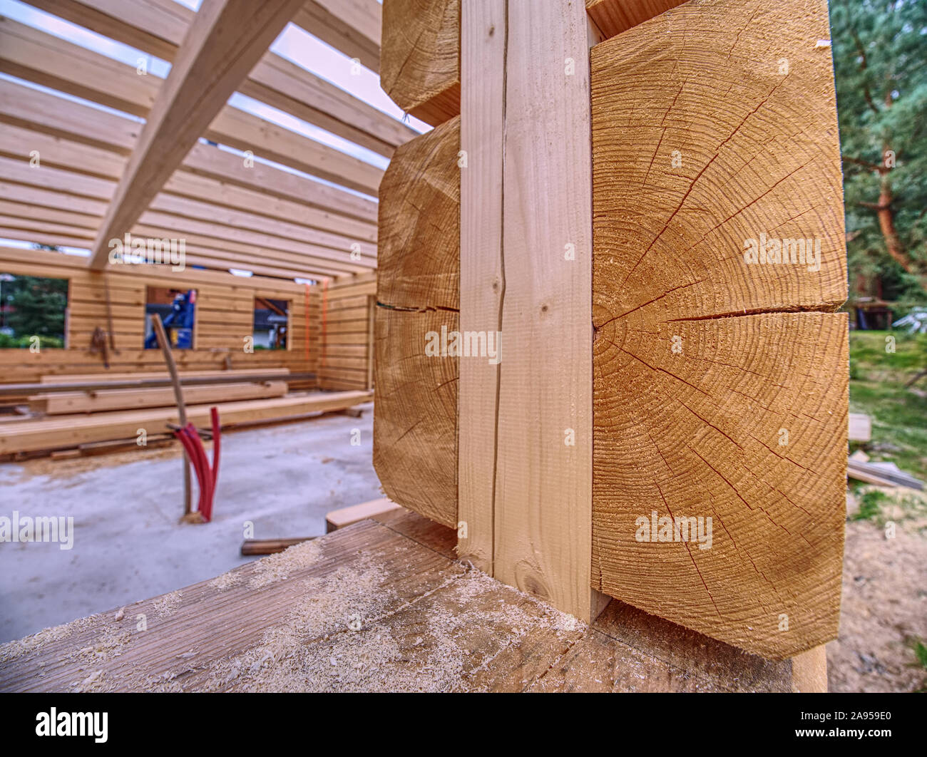 Log wall of modern wooden house under construction, detail of building ...