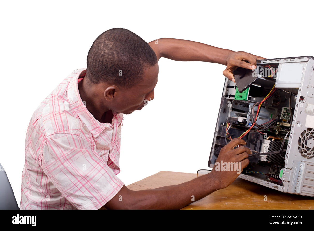 Young technician working on broken computer in his office Stock Photo ...