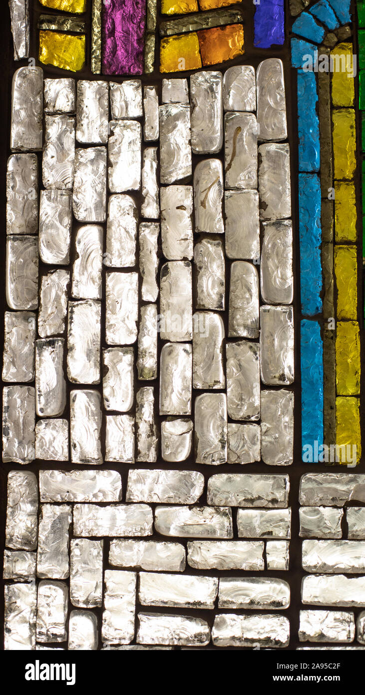 Colored mosaic stained glass window made of glass pieces. Textured ...
