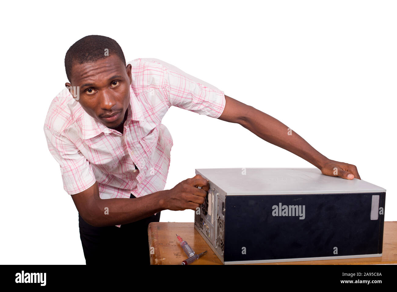 computer support engineer unscrewing a computer. Isolated on a white ...
