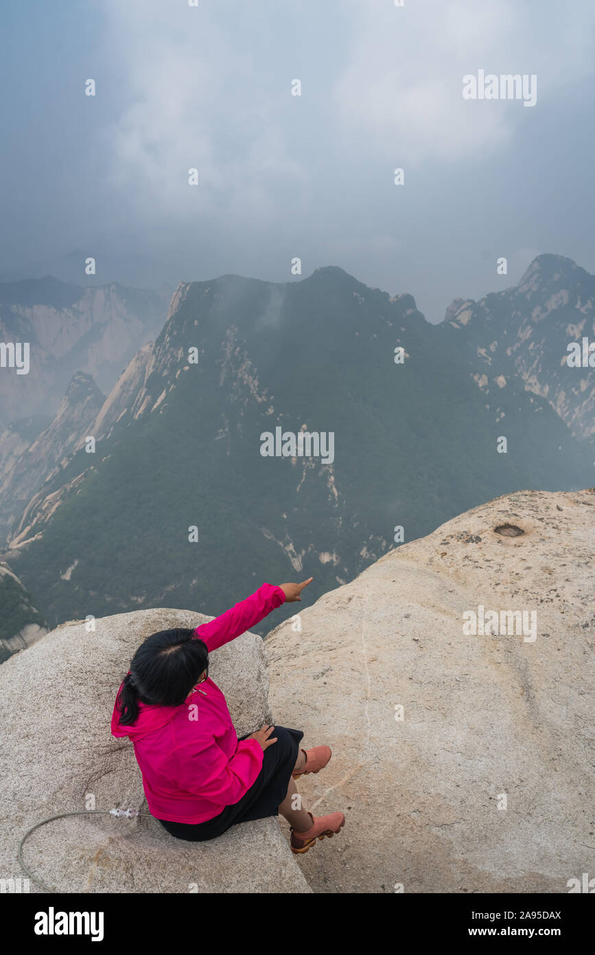 Huashan, China - August 2019 : Tired chinese woman with sitting on a ...