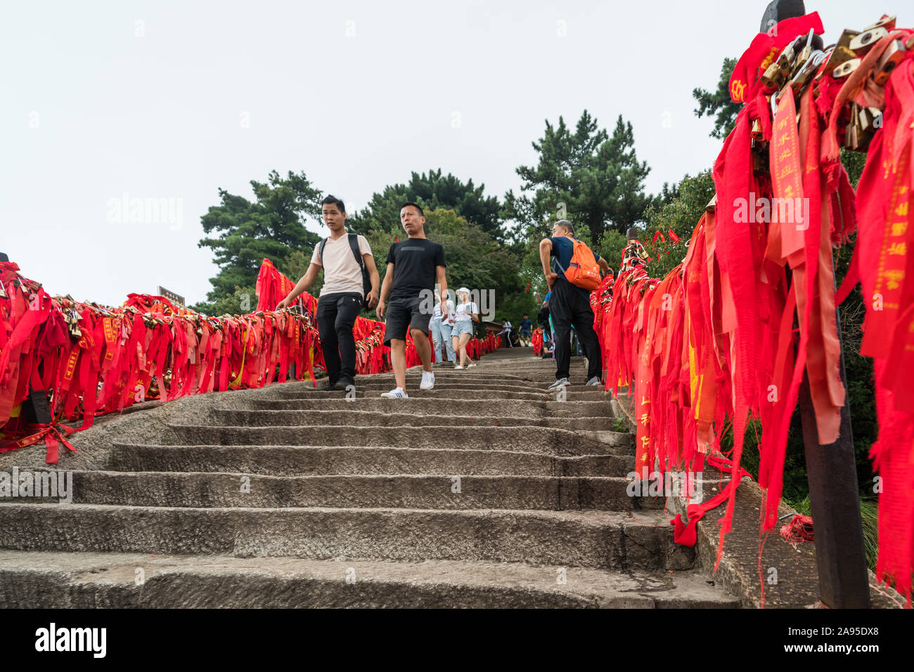 Huashan, China - August 2019 : People walking downhill on stony steps ...