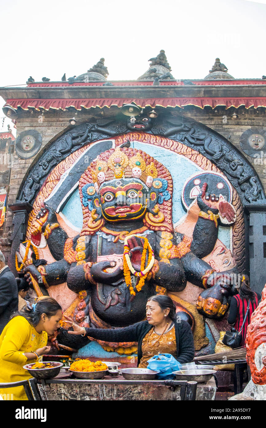 A female Hindu devotee getting blessings from a Hindu priestess in ...