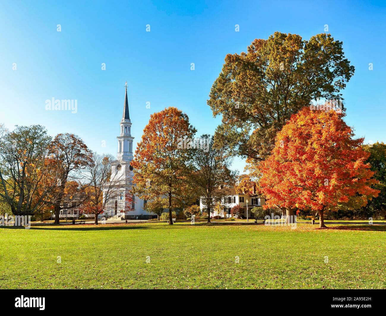 Green area with autumnal trees and church in a park, Lexington Battle ...