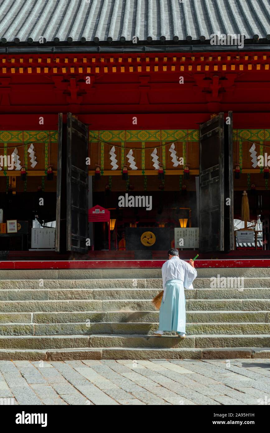 Monk sweeping a staircase with a broom, Nikko Futarasan shrine, shrines ...