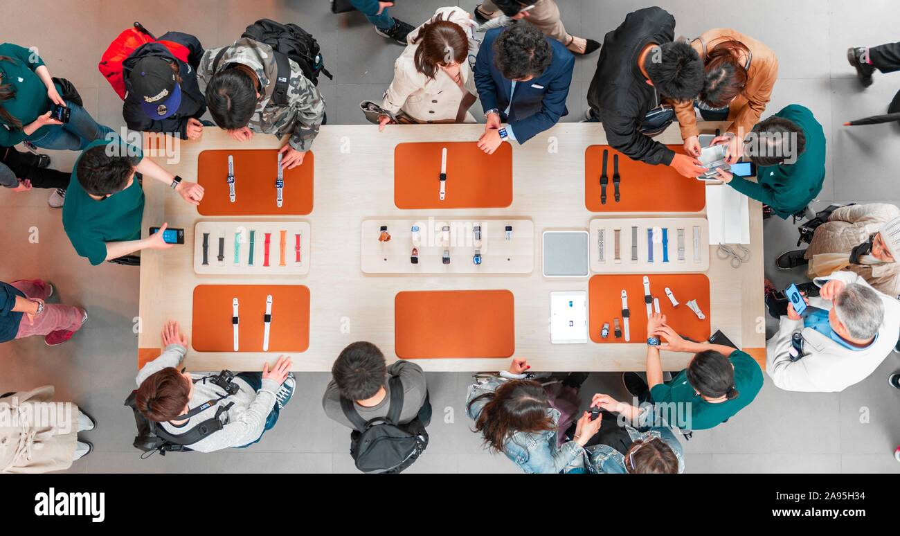 Crowd at the Apple Store shopping, table with watches, iWatch, Ginza ...