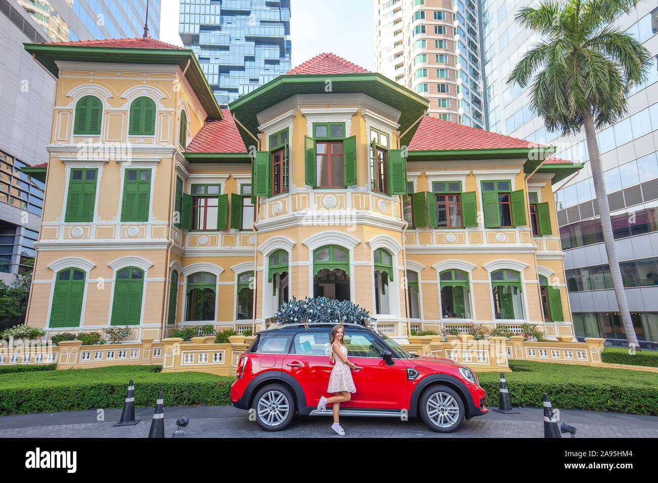 Smiling Pretty Girl Near the Red Retro Mini Cooper car with Christmas ...