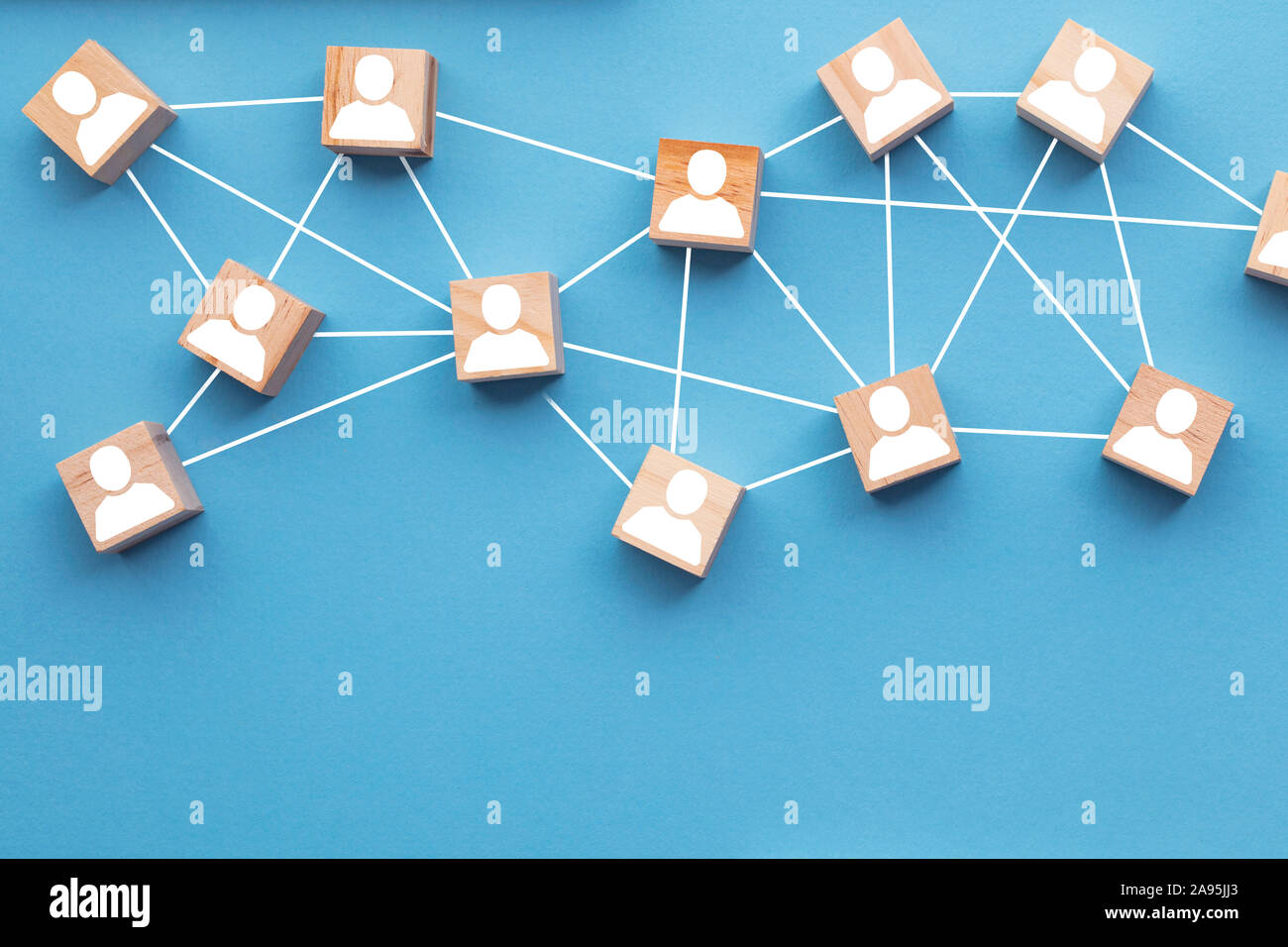 Wooden blocks connected together on a blue background. Teamwork concept ...