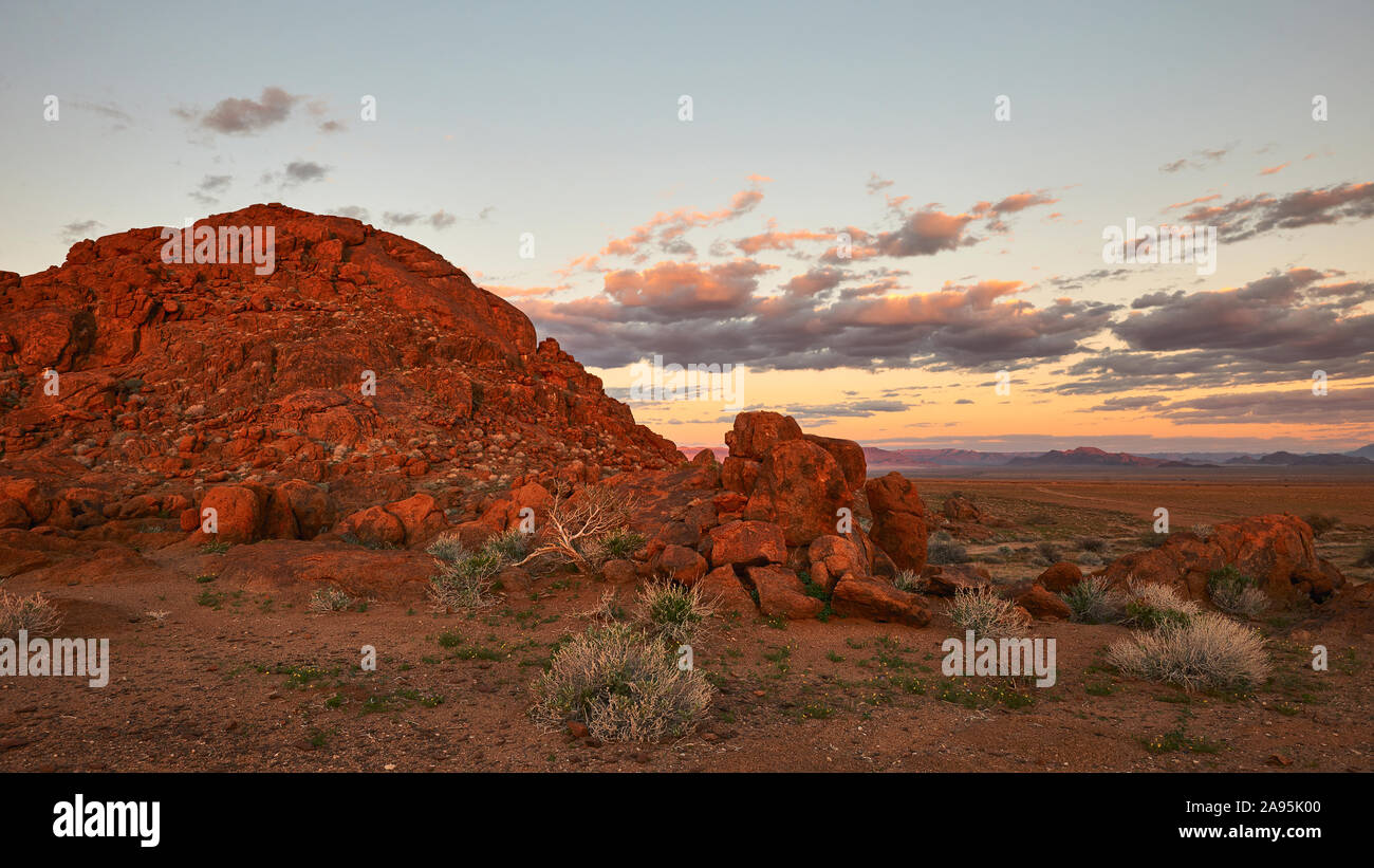 Namibian sunset landscape with big red rocks Stock Photo - Alamy