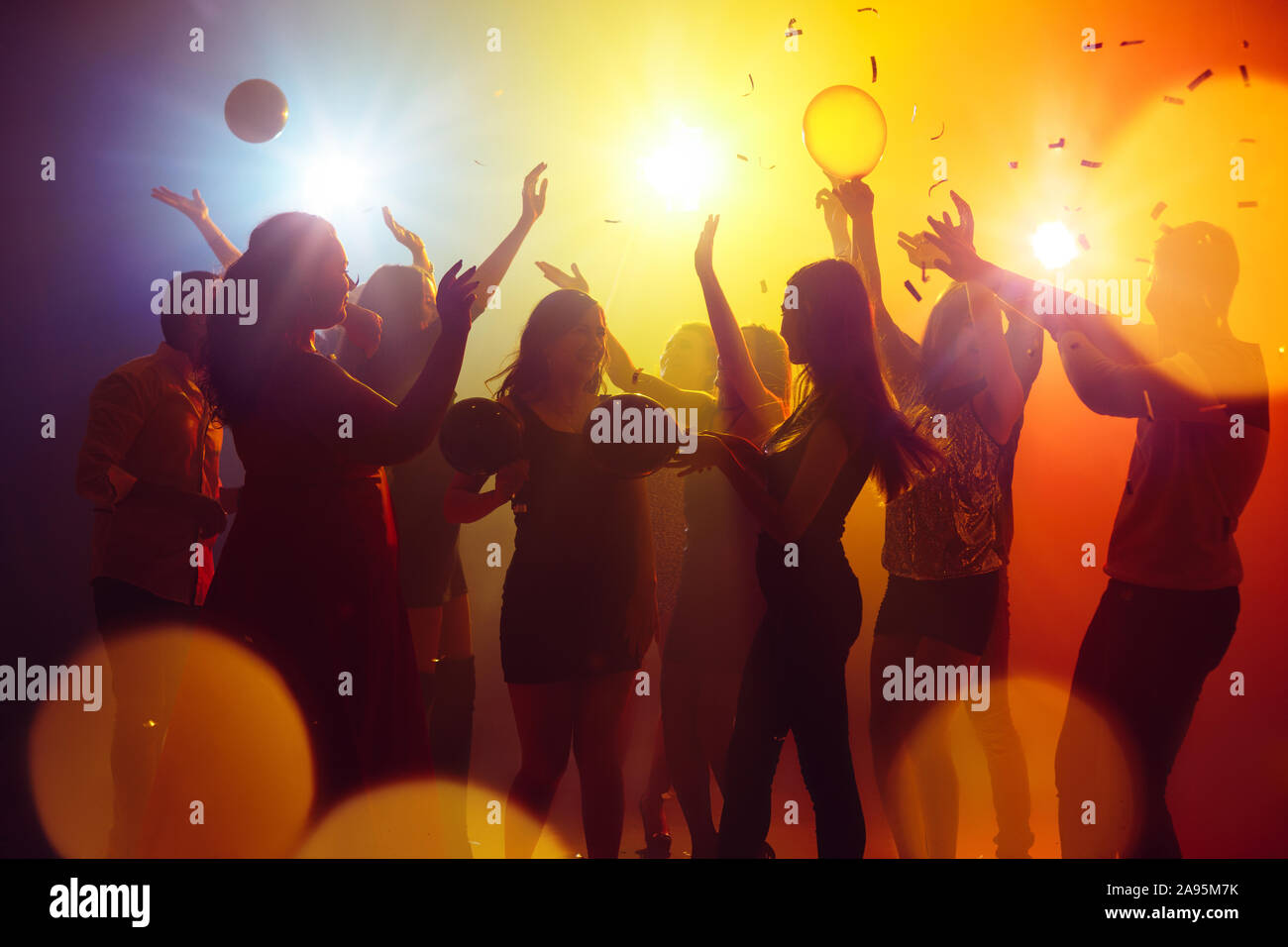 Emotions. A crowd of people in silhouette raises their hands on ...