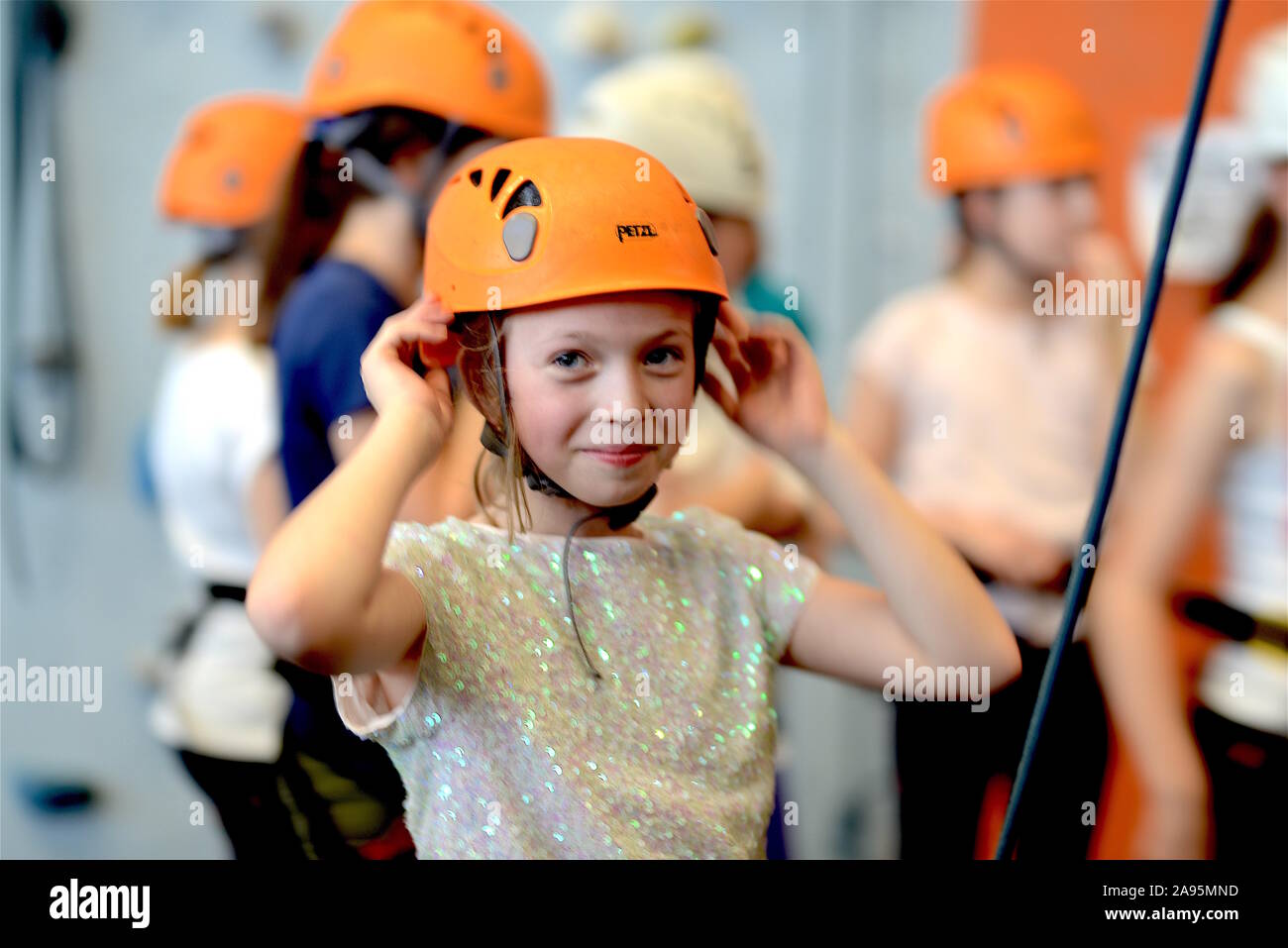 Girl excited by climbing wall Stock Photo - Alamy