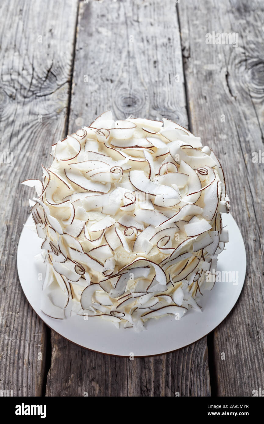 rustic style of a whole coconut cake decorated with coconut ribbons ...