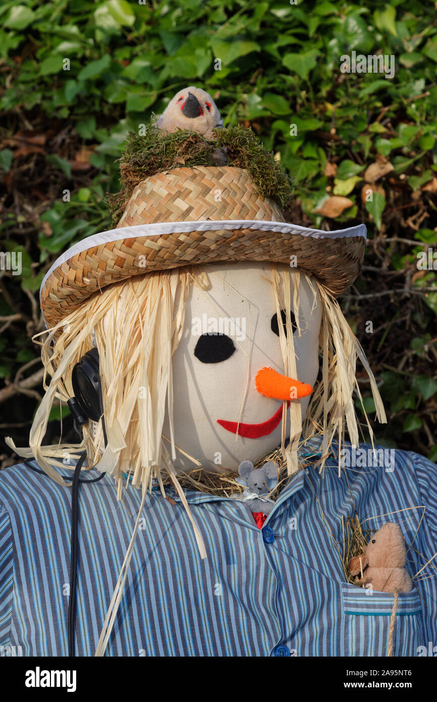 Close up of the head of a friendly scarecrow wearing pyjamas and a ...