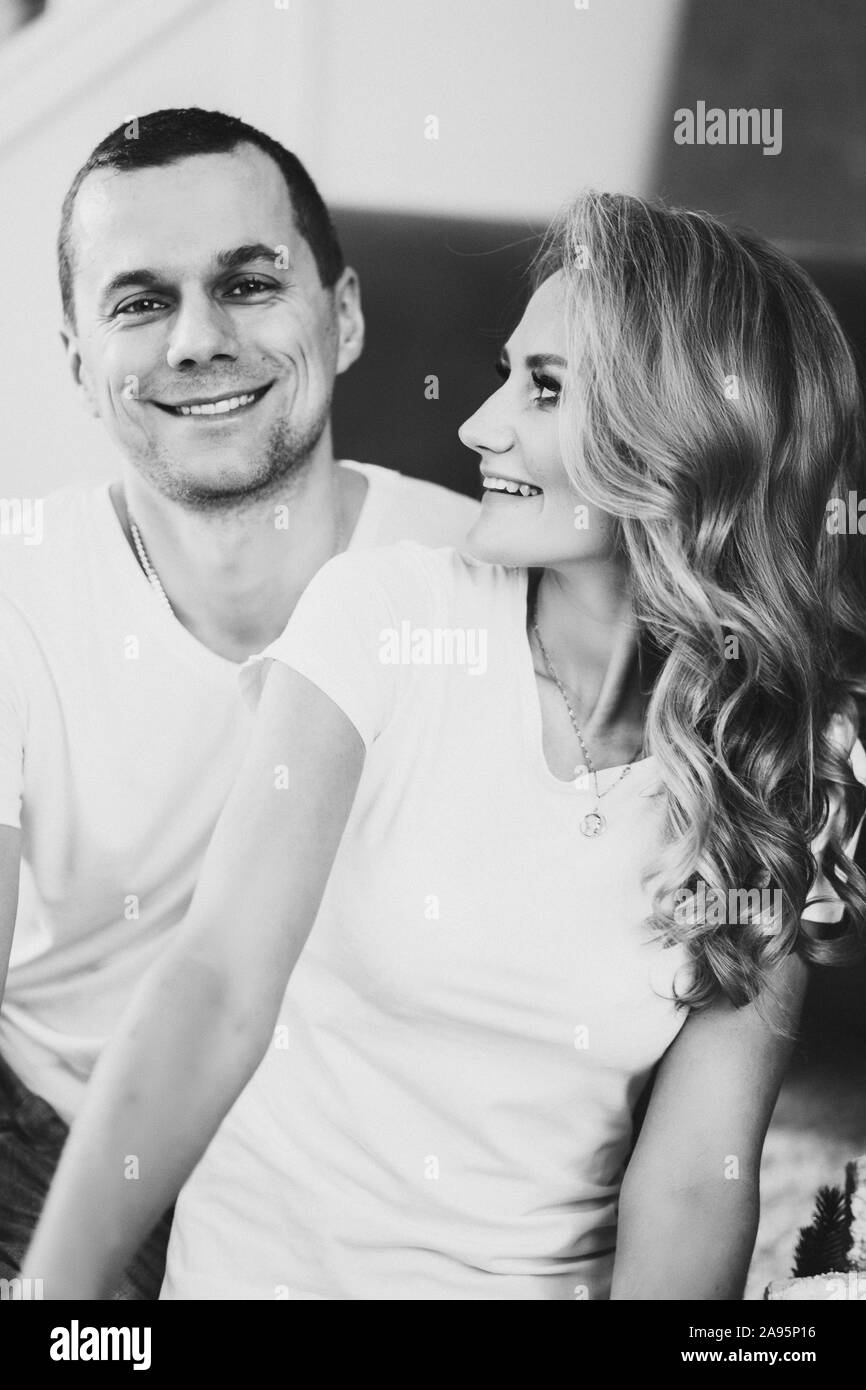 Loving boyfriend kissing girlfriend near Christmas tree Stock Photo - Alamy