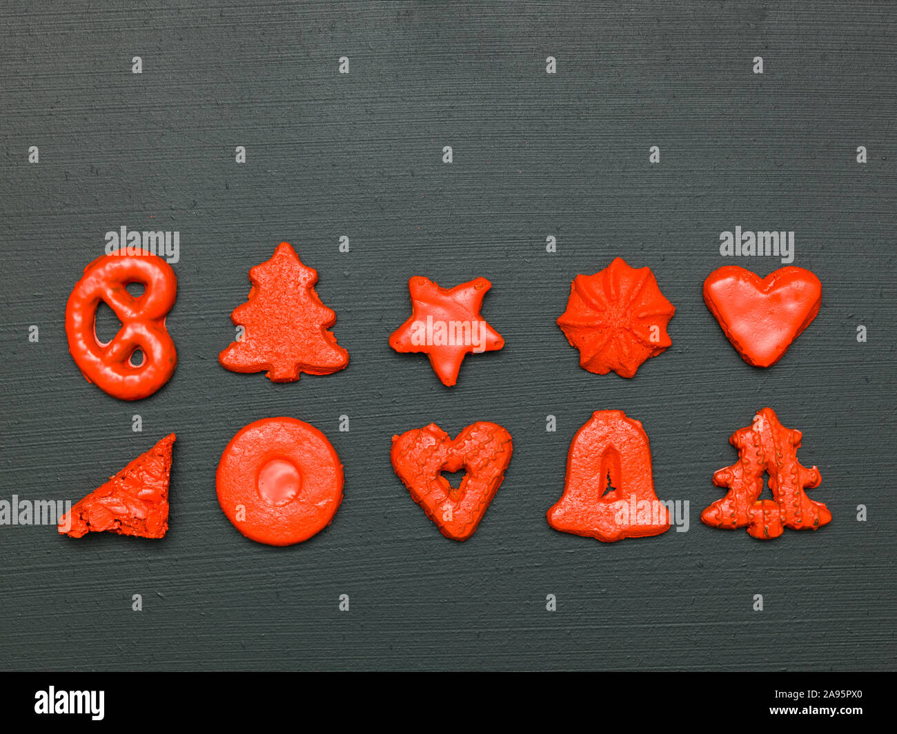red christmas cookies on black wooden background from above Stock Photo ...