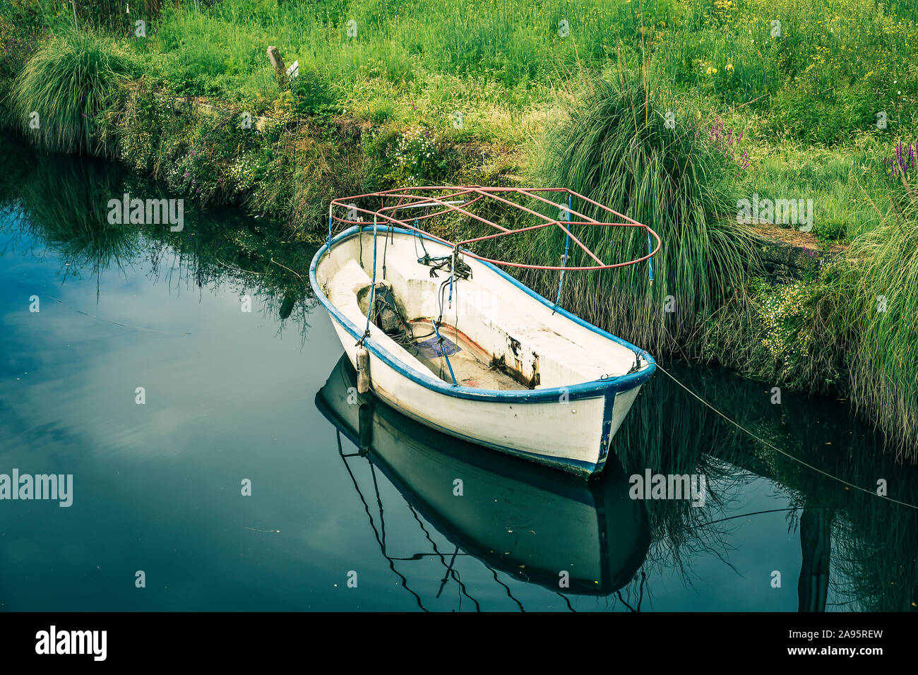 solitary fishing boat floating on the river Stock Photo - Alamy