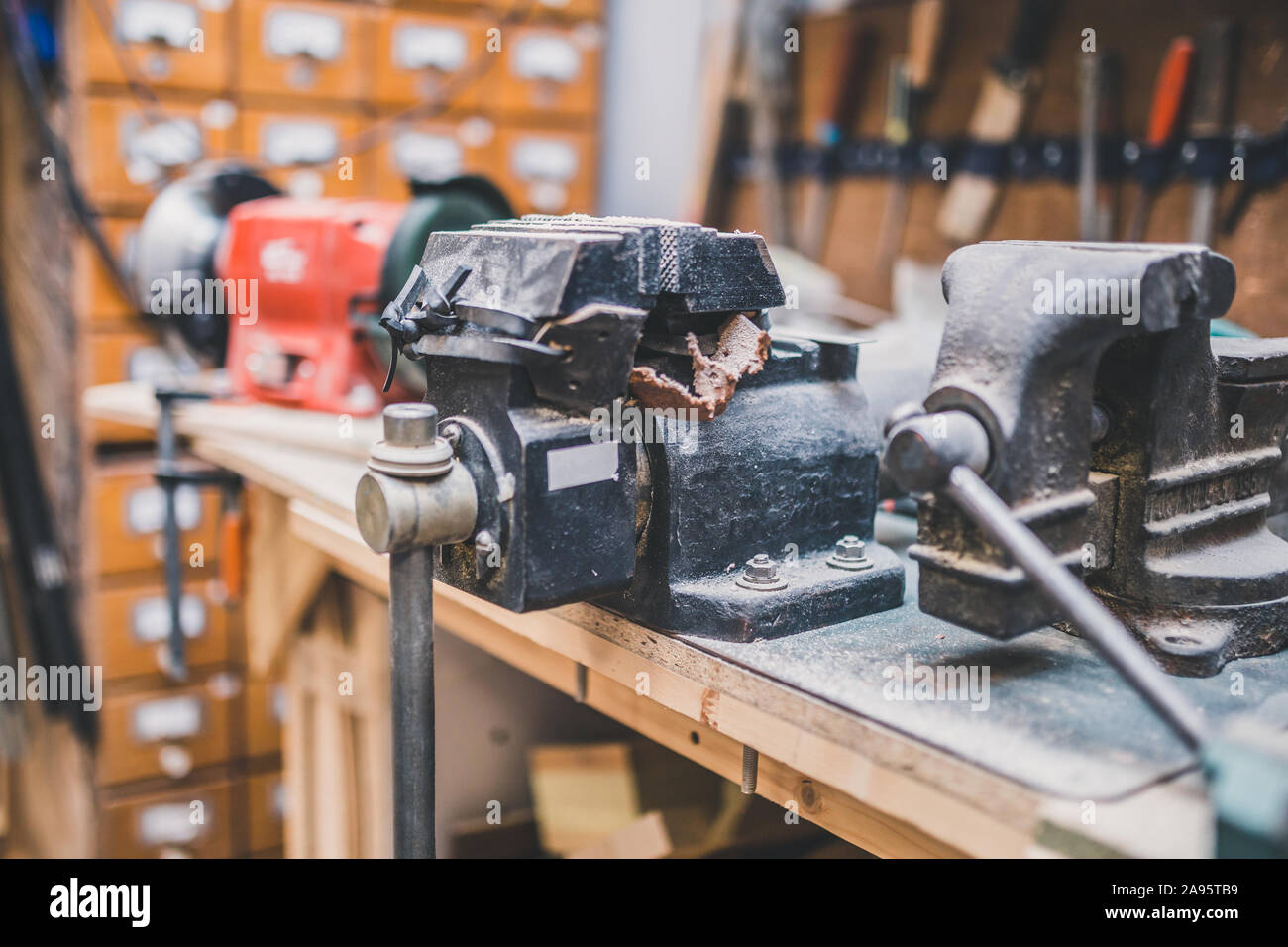 Carpentry workshop - heavy metal vice on a workbench Stock Photo - Alamy