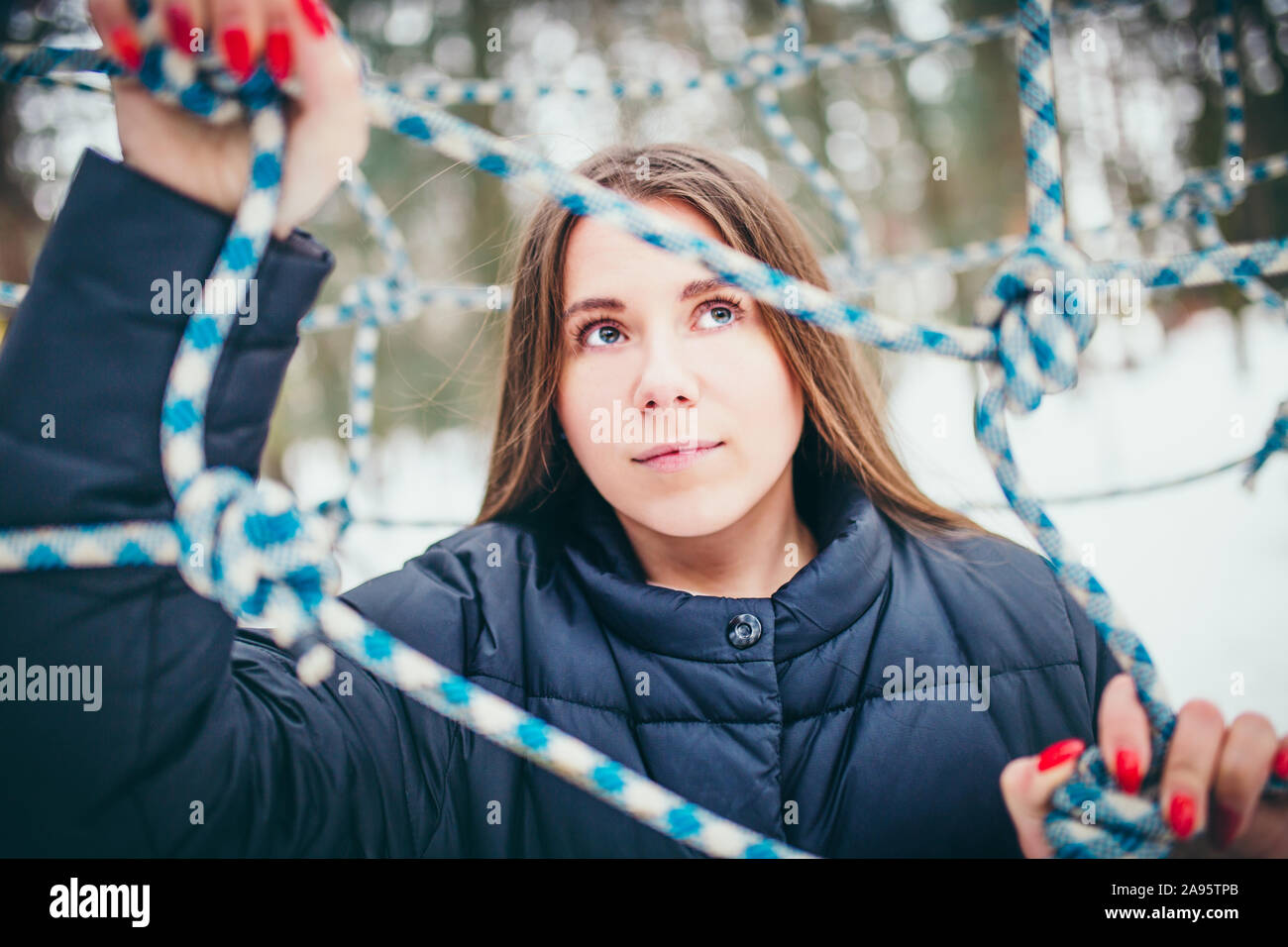 The face of an attractive young brown-haired woman looks dreamily into ...