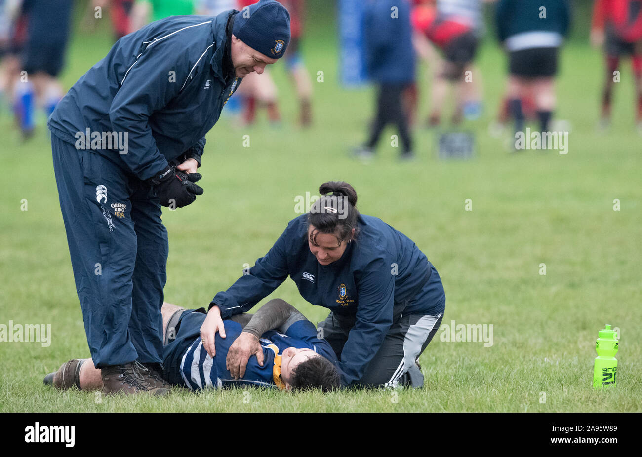 Male amateur rugby union football player receiving medical treatment ...
