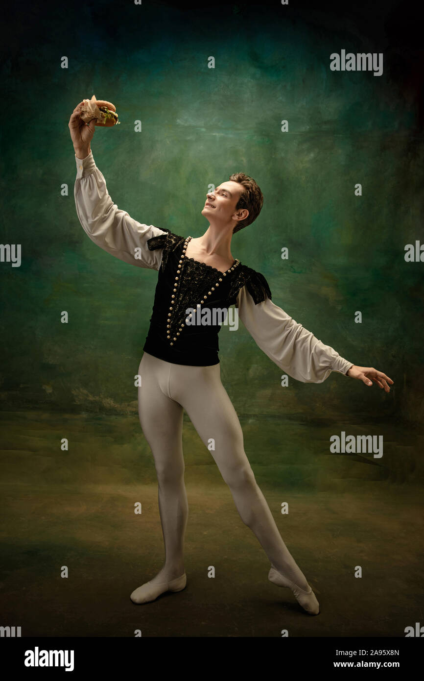 Young ballet dancer as a Snow White's character with burger in forest ...
