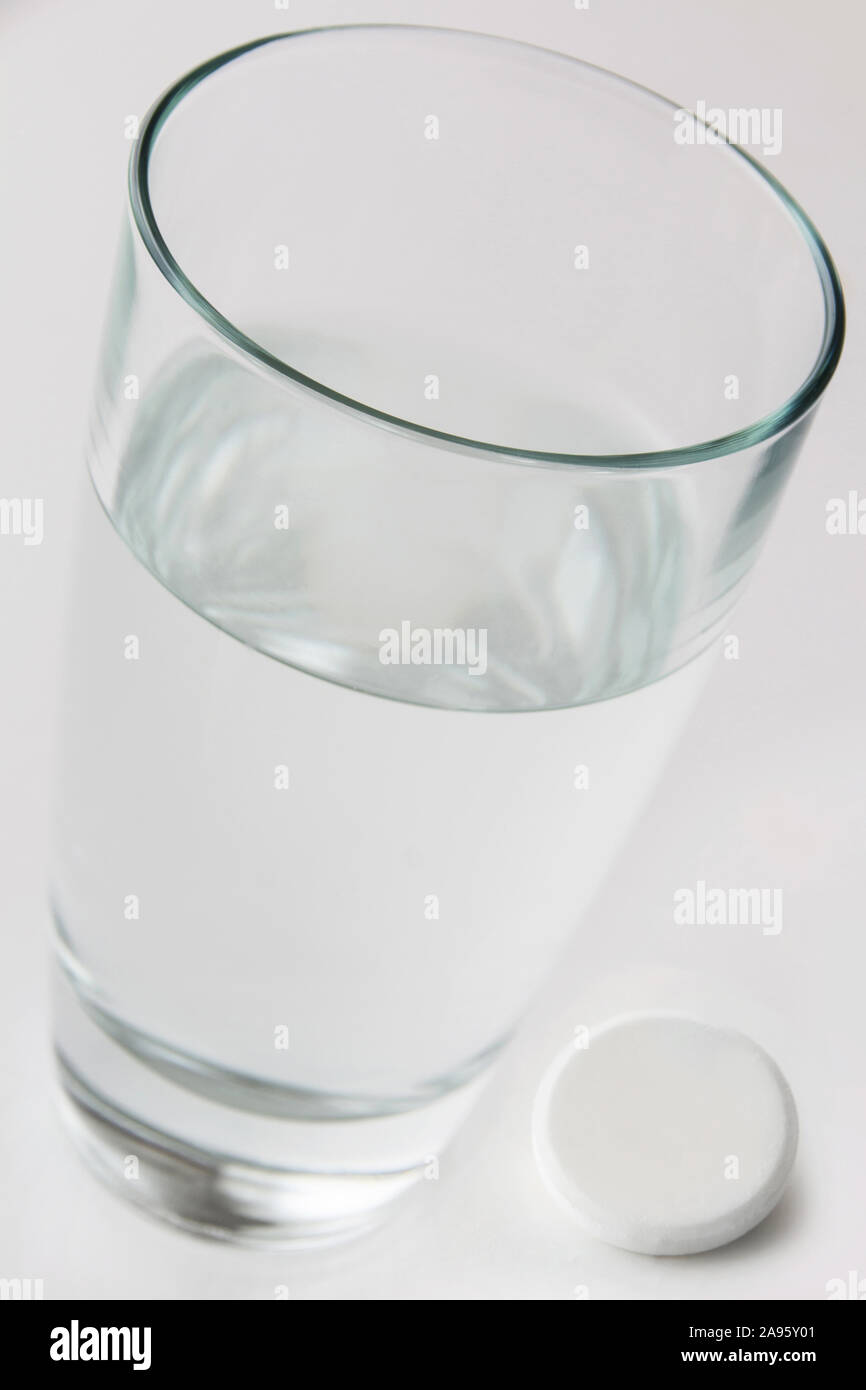Tablet and a glass of water Stock Photo - Alamy
