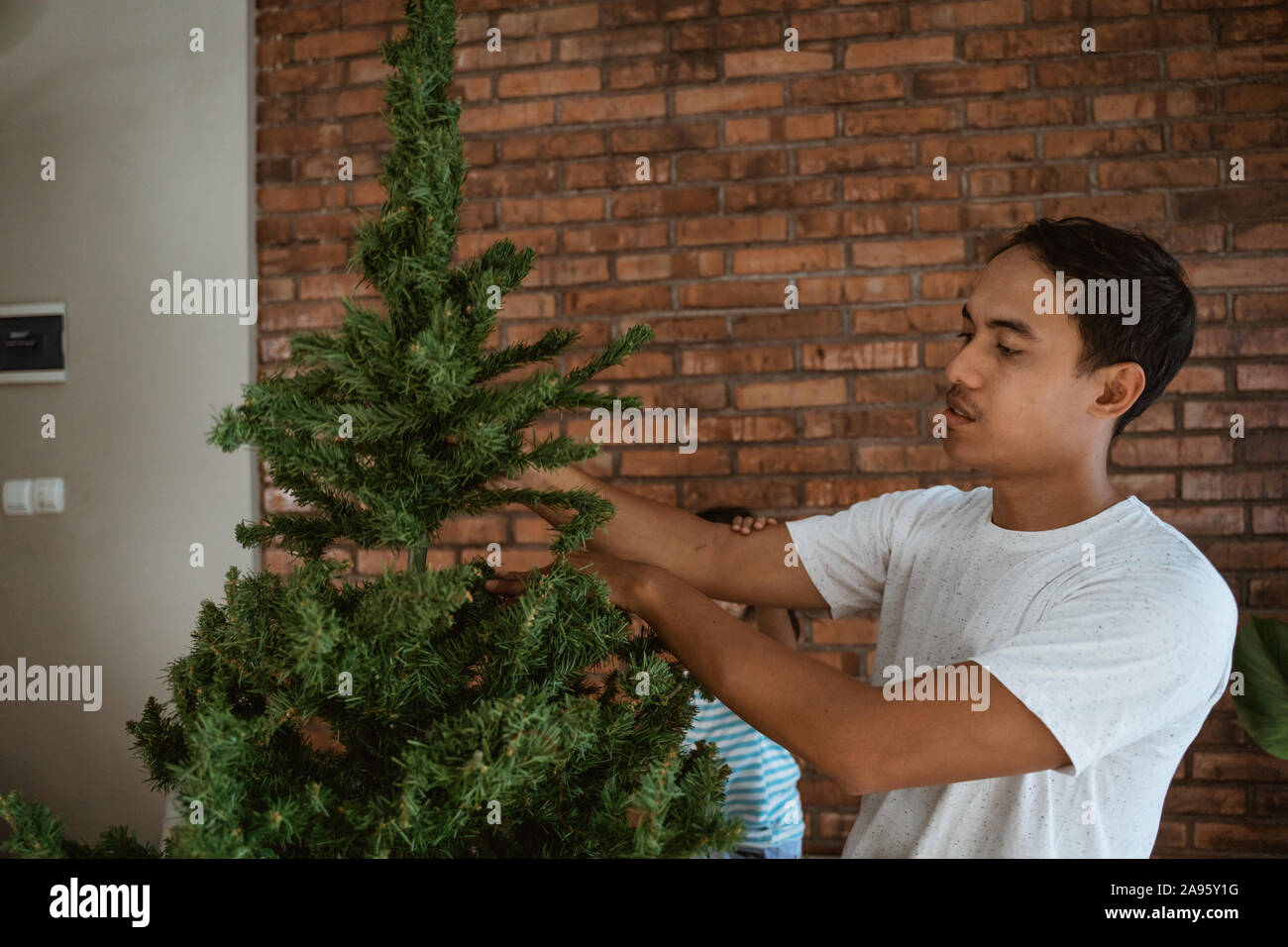 Buying installing christmas tree hi-res stock photography and images ...
