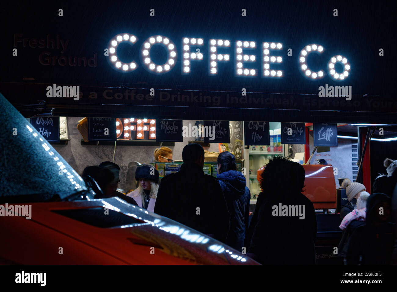 A mobile coffee stall at a venue. Customers being served at night Stock ...