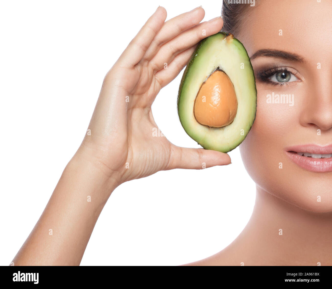 Young beautiful woman with avocado fruit on white background Stock ...