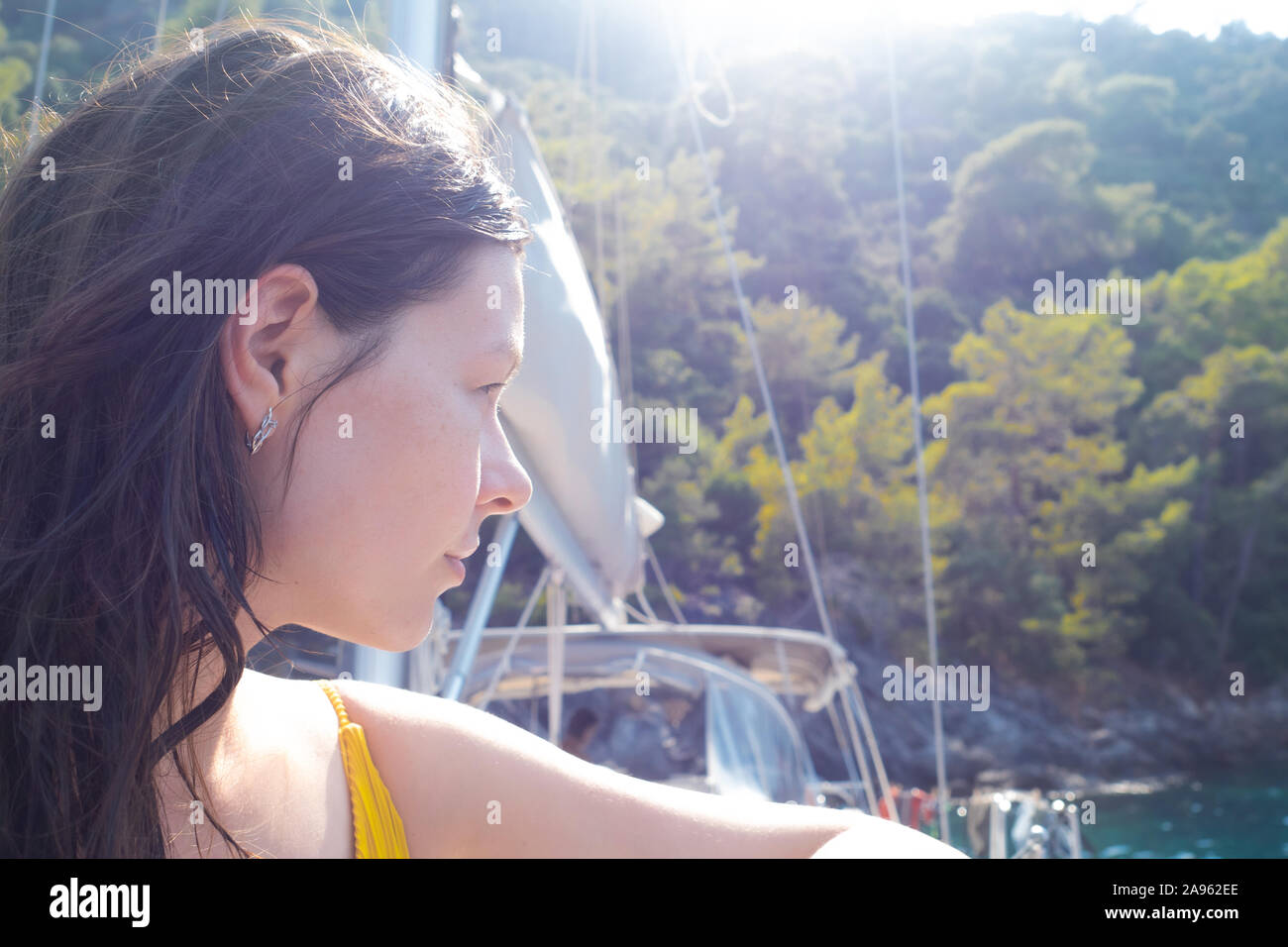 Happy young woman resting on the sea, portrait on the deck of a yacht ...