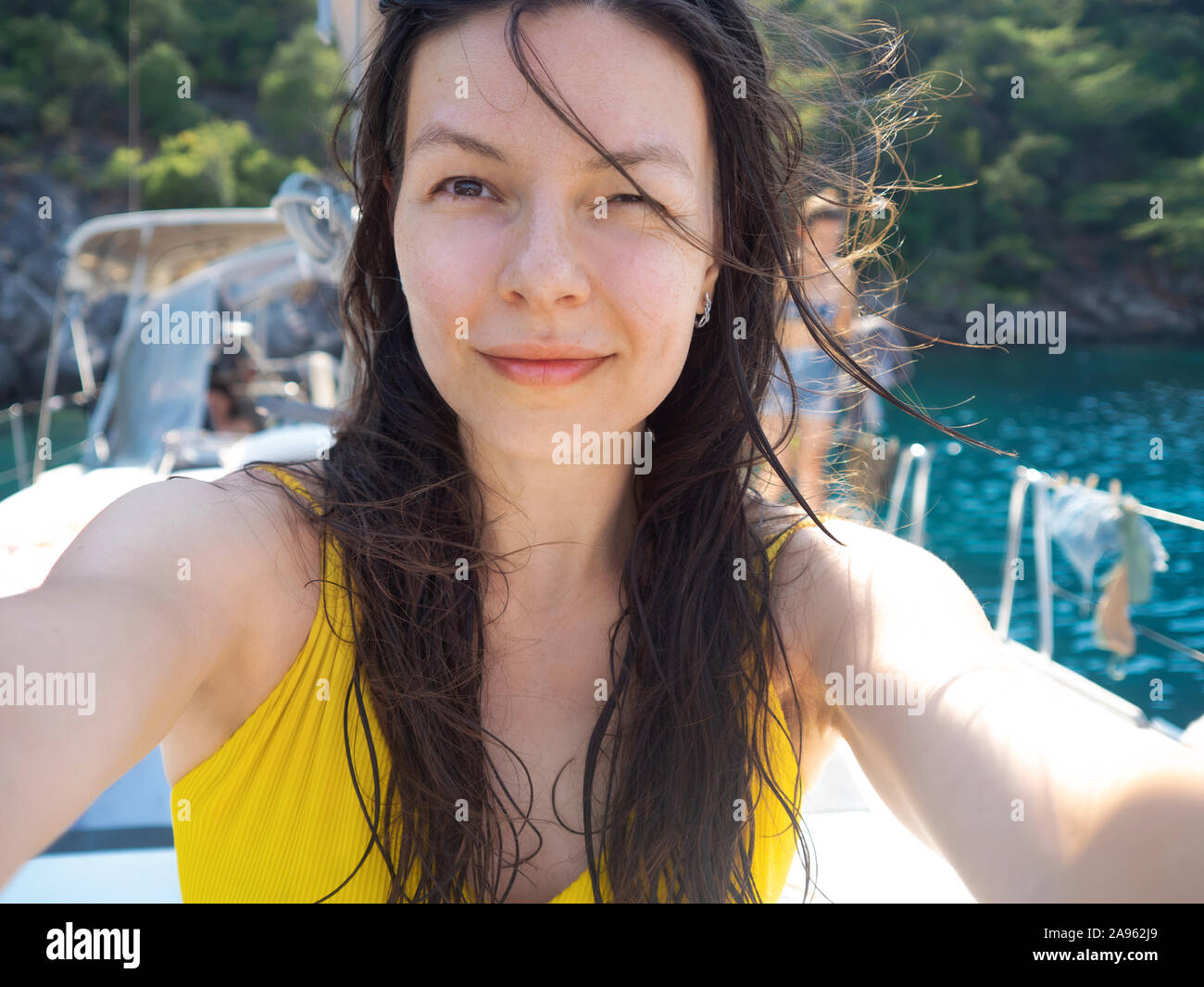 Selfie Portrait Of A Positive Multi Ethnic Girl In A Yellow Swimsuit On Board A Yacht Boat Trip