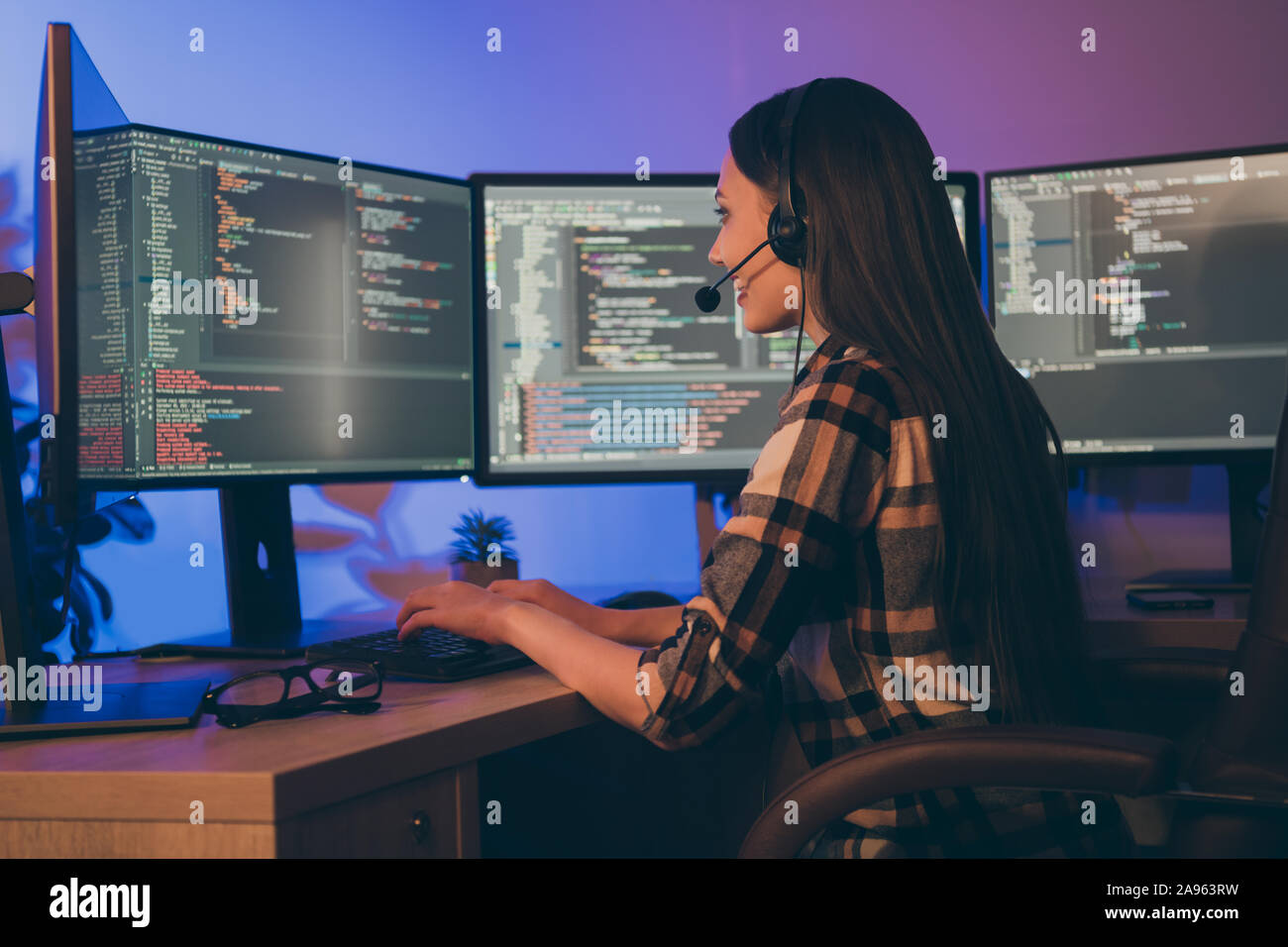 Photo of hard-working programmer consulting her colleagues at late ...