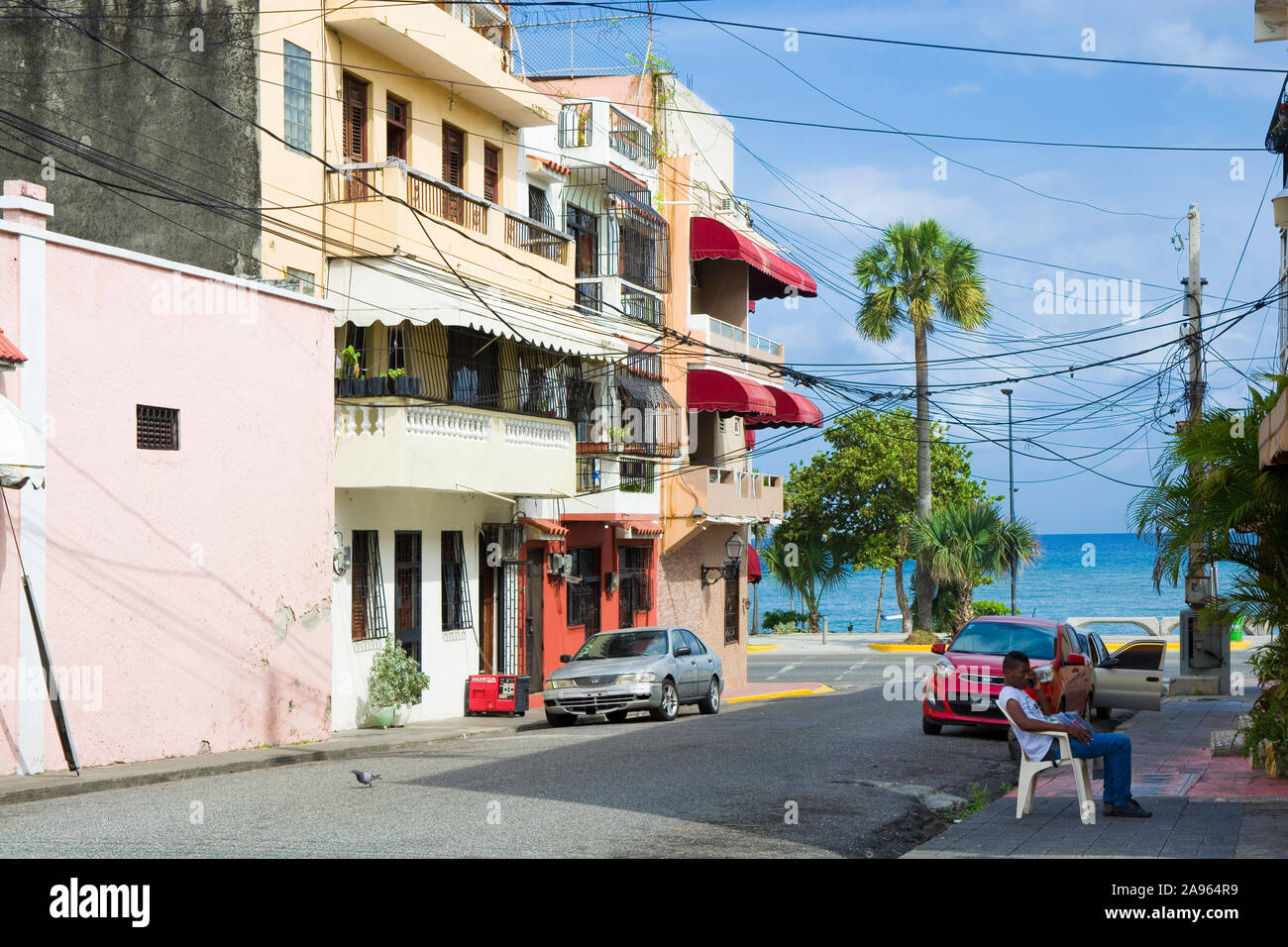 SANTO DOMINGO, DOMINICAN REPUBLIC - JUNE 26, 2019: Man sitting and ...