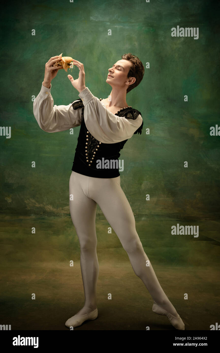 Young ballet dancer as a Snow White's character with burger in forest ...