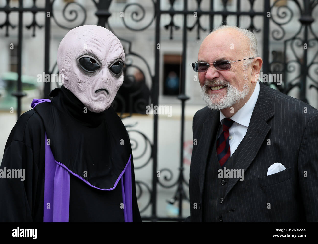 Senator David Norris (right) joins an actor dressed as an alien outside ...