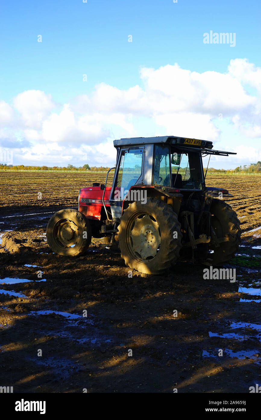 Tractor in a muddy field near Stanford in Bedfordshire Stock Photo - Alamy
