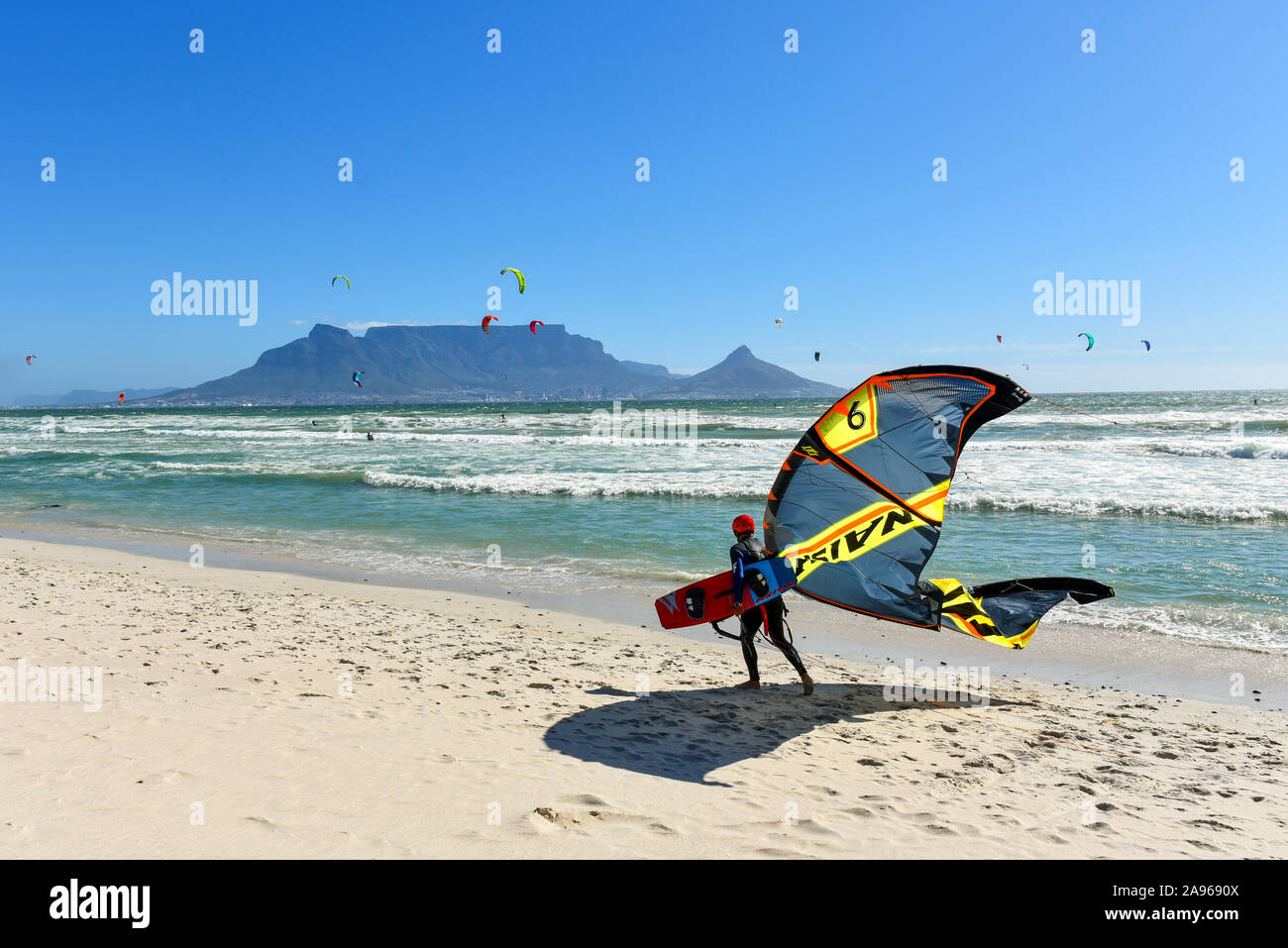 A Kite surfer walking on the beach in Cape Town, South Africa Stock ...