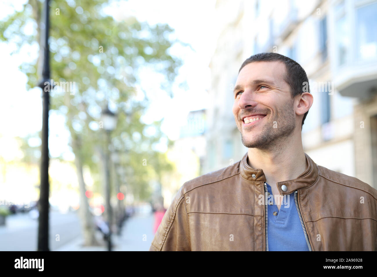 Front view portrait of a happy adult handsome man looking at side in ...