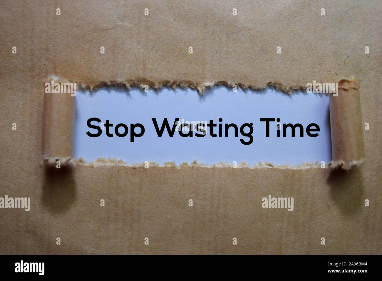 Stop Wasting Time Text written in torn paper Stock Photo - Alamy