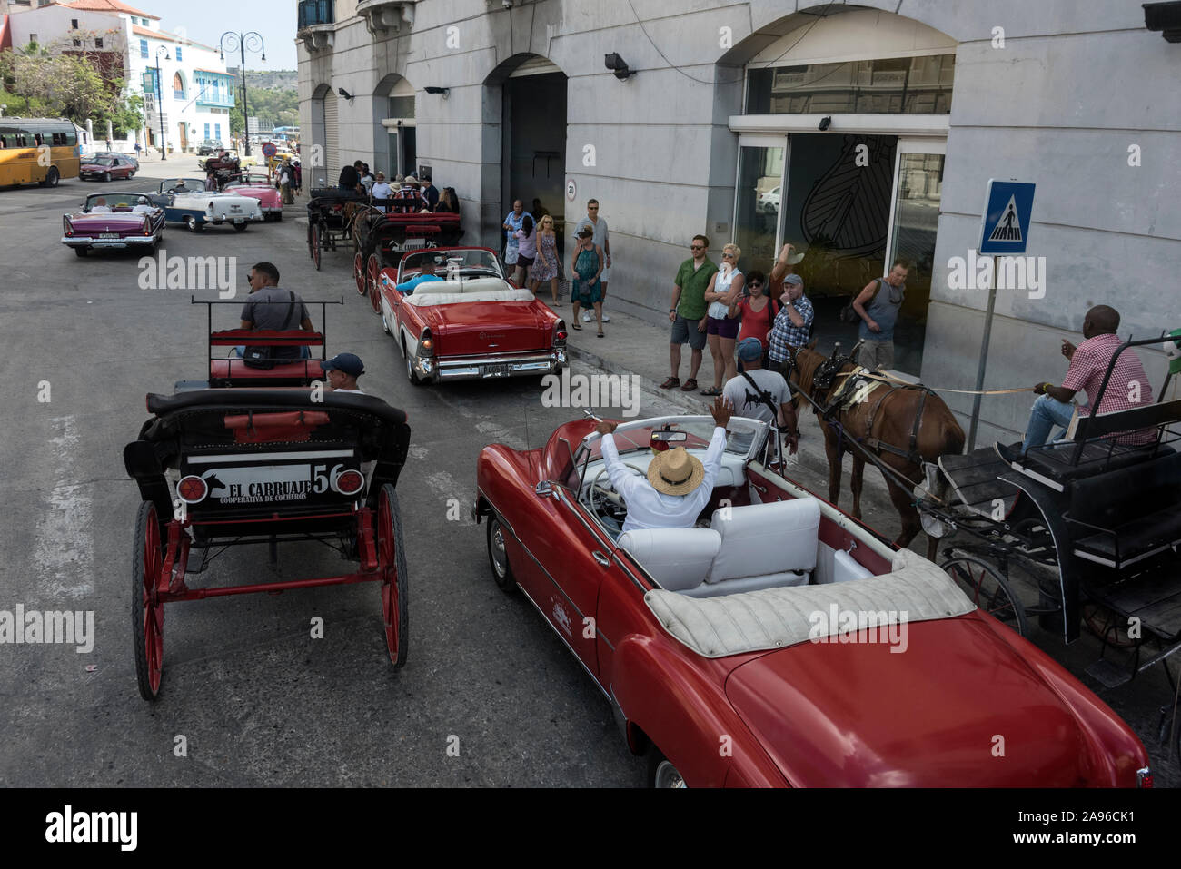 A fleet of American classic cars and horse drawn carriages, waiting for ...