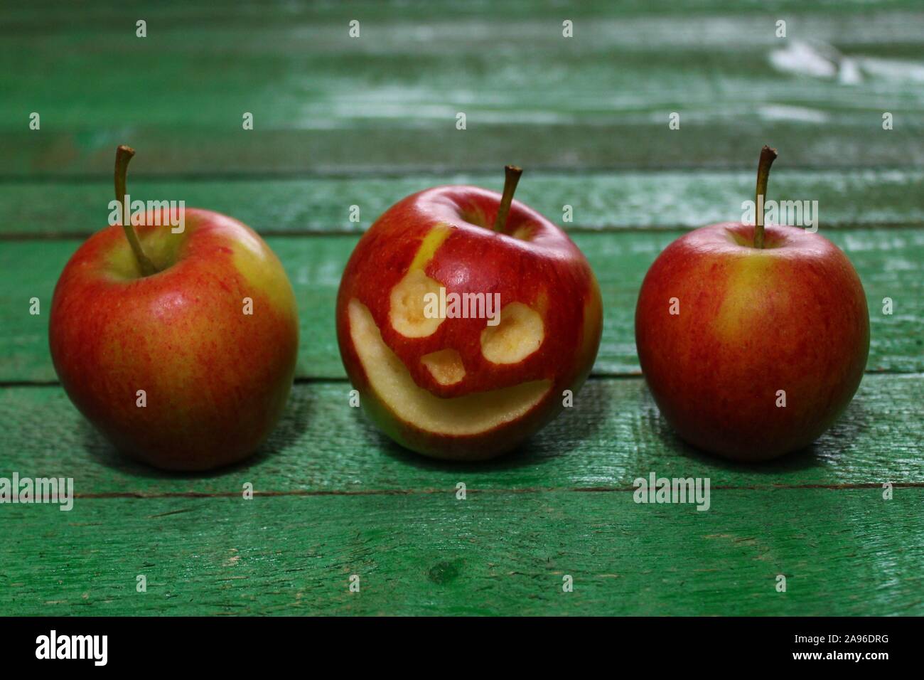 The picture shows two apples and a apple with a face Stock Photo - Alamy