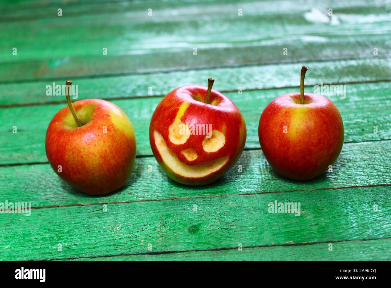 The picture shows two apples and a apple with a face Stock Photo - Alamy