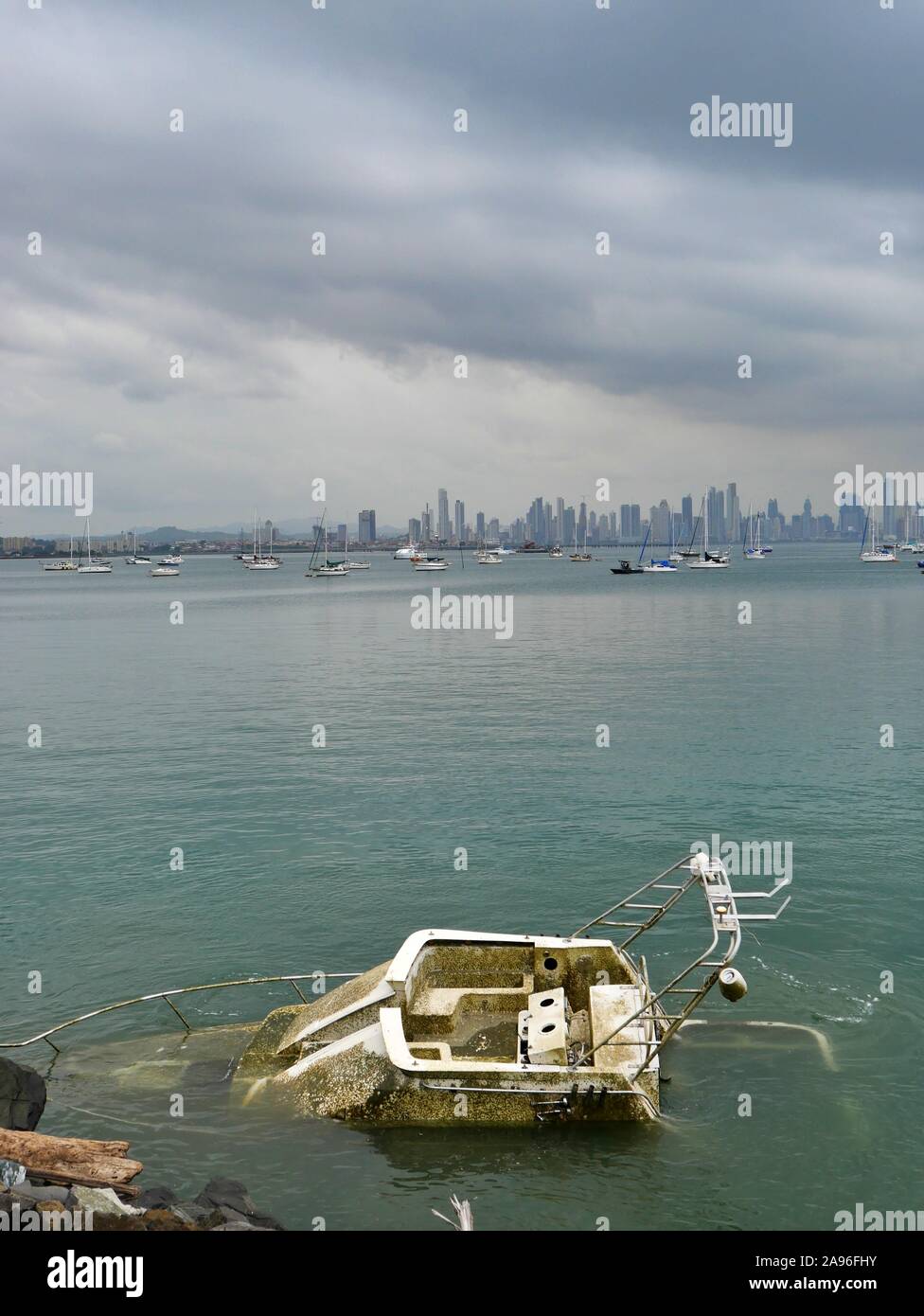 sinking ship in port in front of a skyline Stock Photo - Alamy
