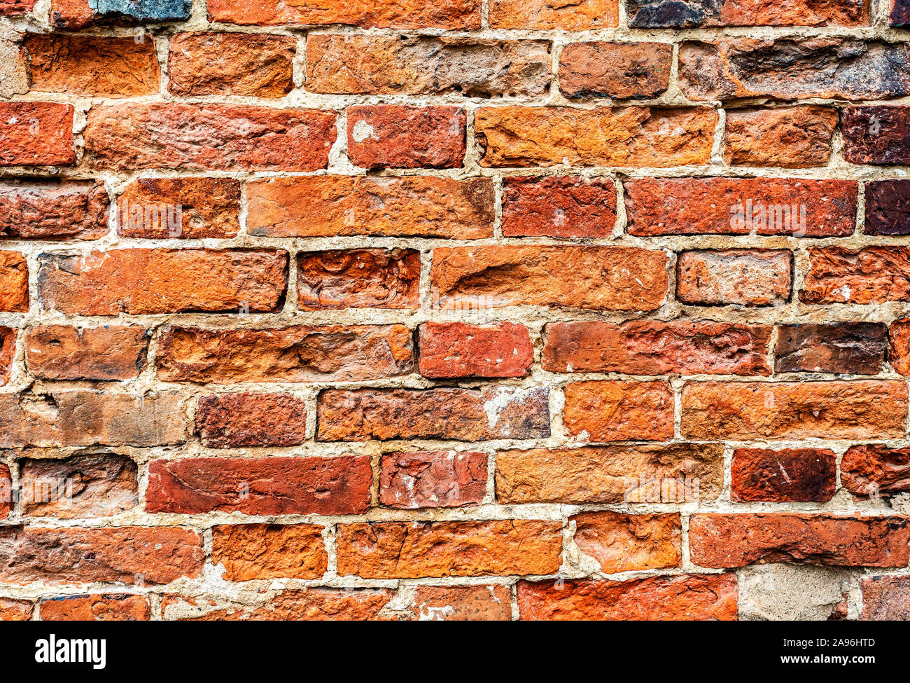 Rough red brick wall as background texture. Bricks masonry with uneven ...