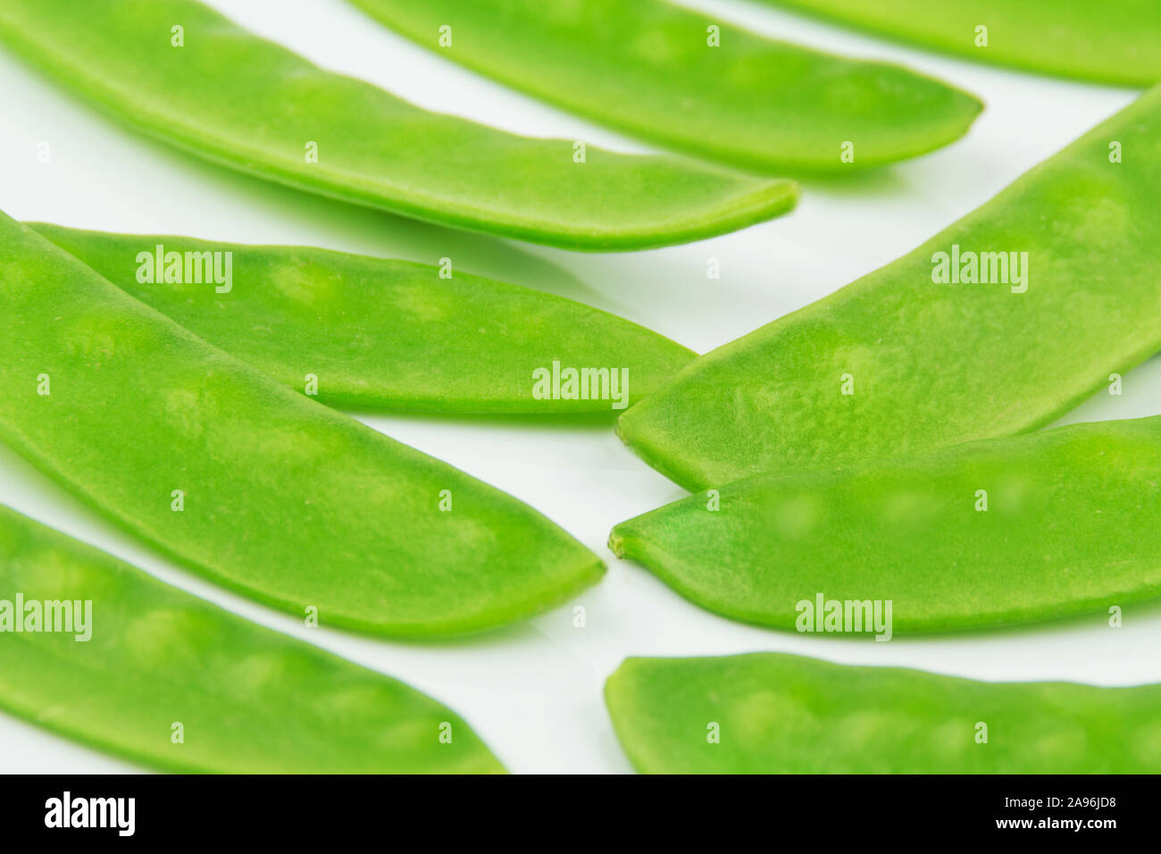 Snow pea against a white background Stock Photo - Alamy