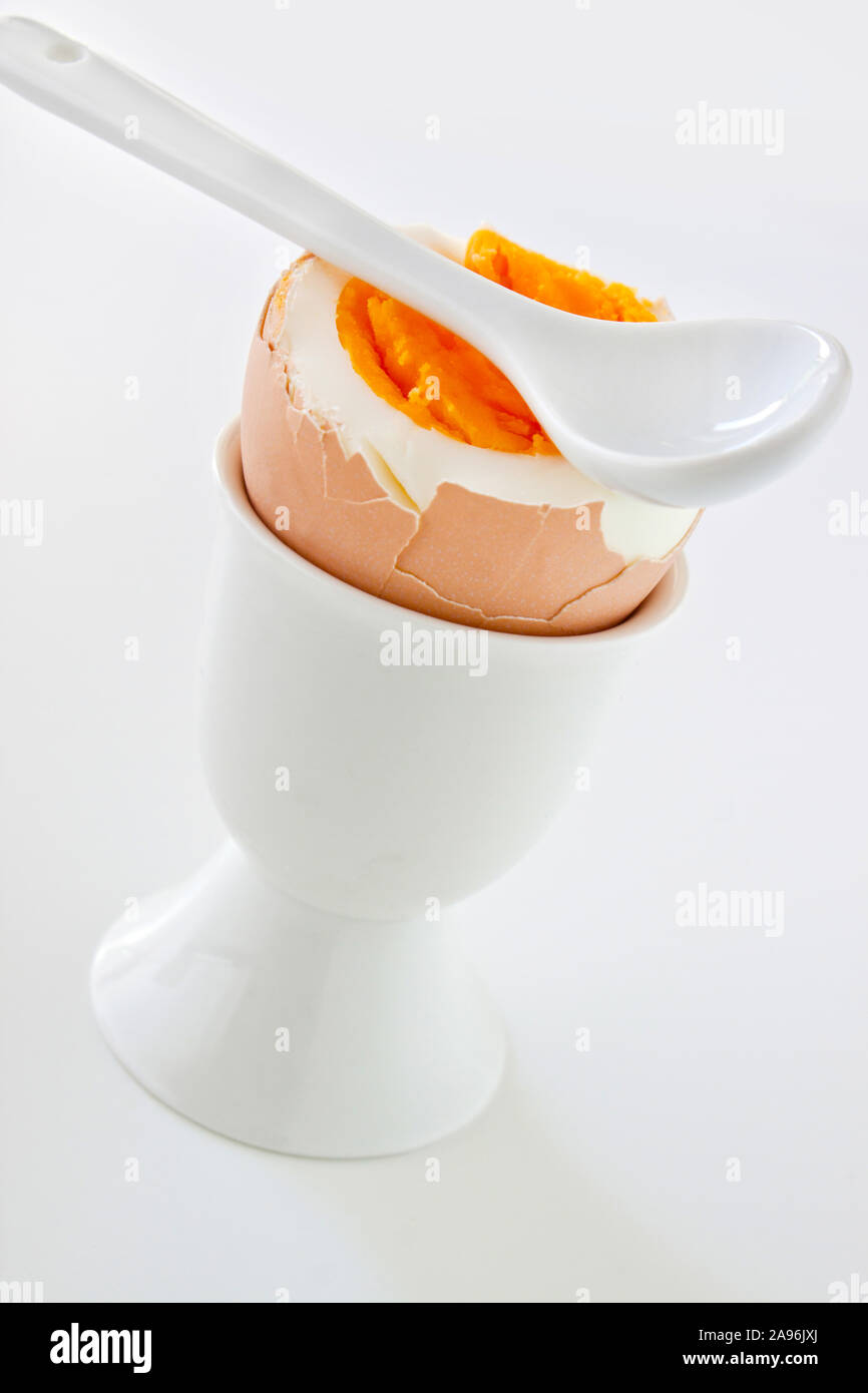 Boiled egg and egg cup with spoon Stock Photo - Alamy
