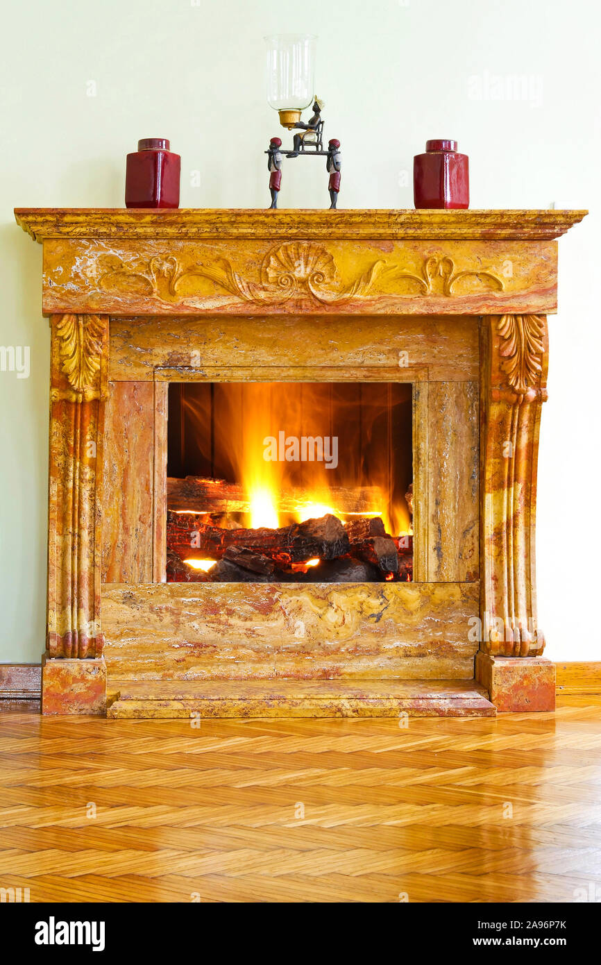 Interior with luxurious yellow marble fire place Stock Photo - Alamy