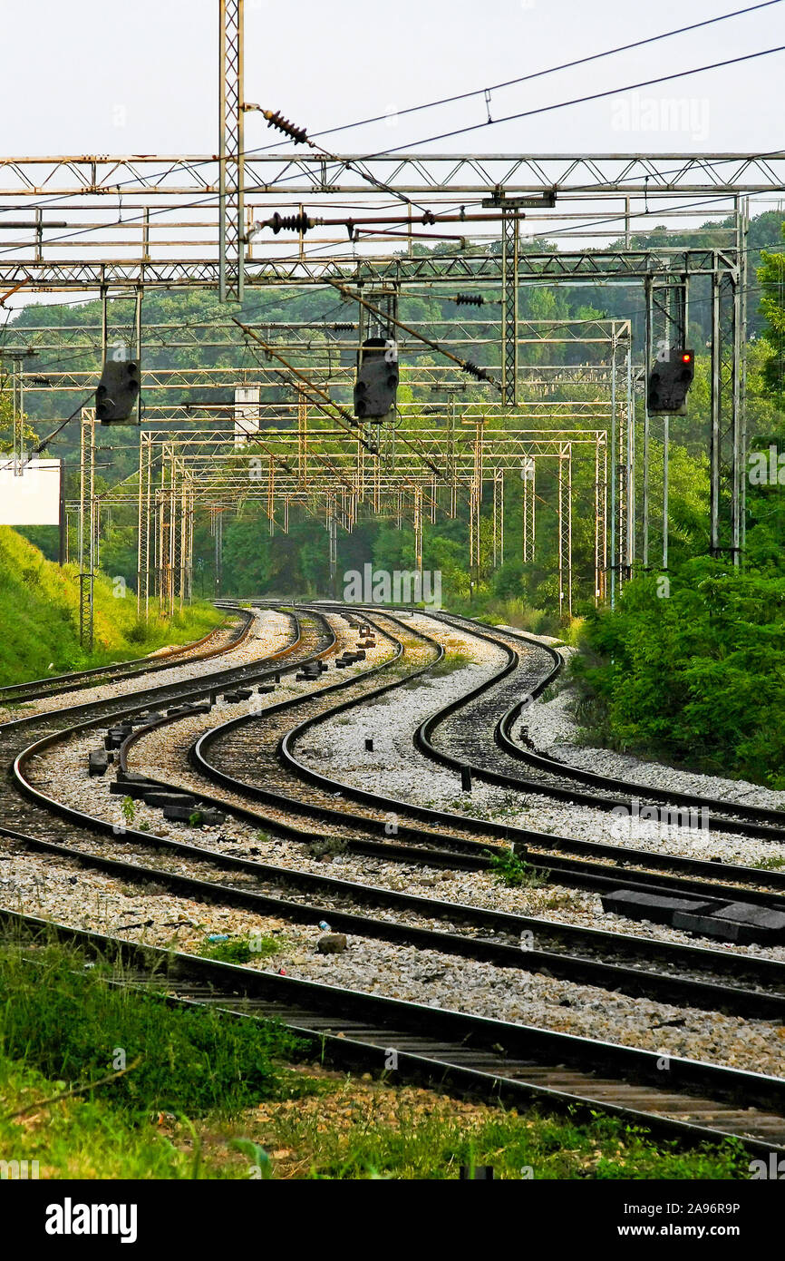 Four lane railroad with double curve tracks Stock Photo - Alamy