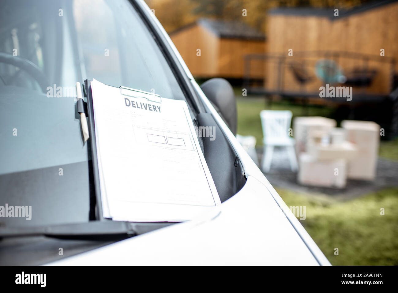 Delivery checklist on the vehicle's windshield and parcels on the ...