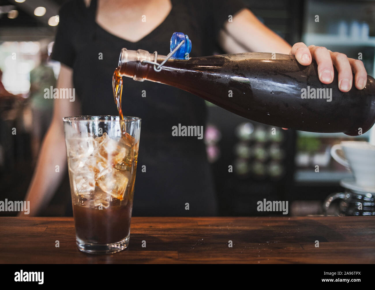 Woman Pouring Cold Brew Coffee Stock Photo - Alamy