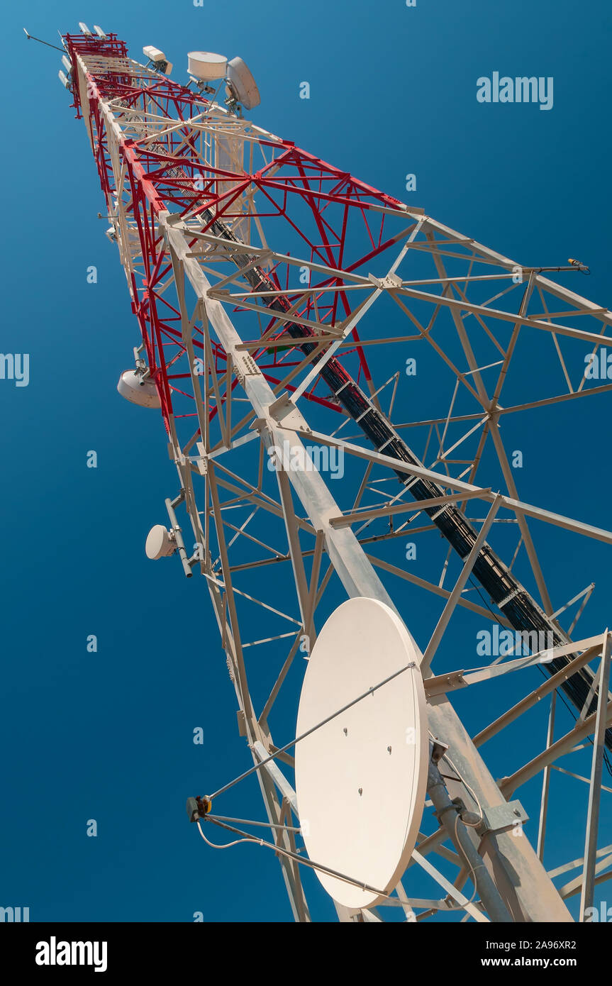 Telecommunications tower with satellite dishes and cellular antennas on ...